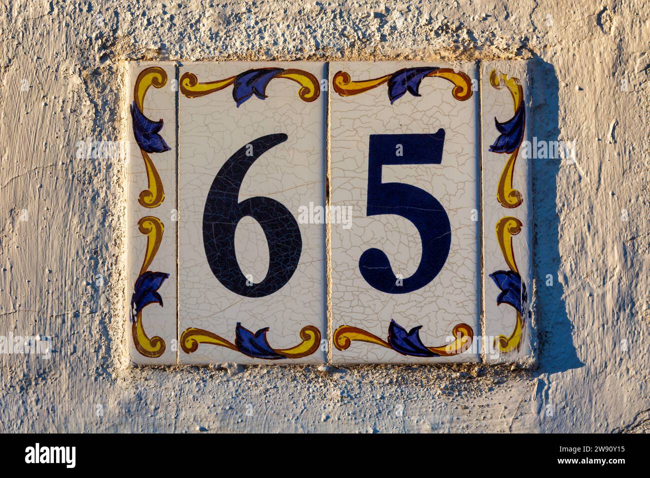 Old Weathered House Number 65, Tile on Wall Stock Photo - Alamy