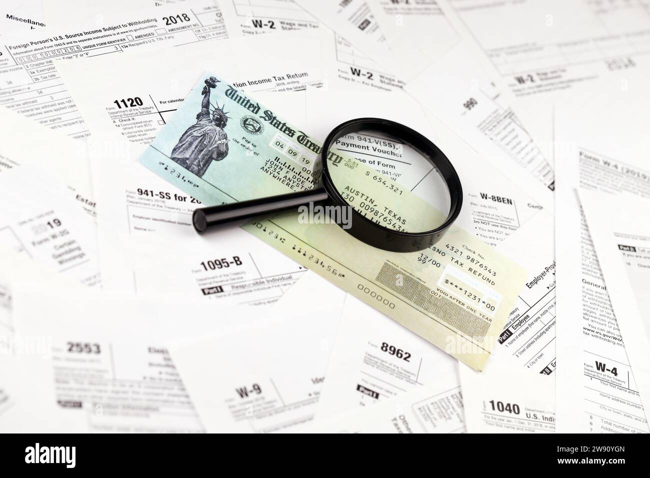 Refund check on many tax form blanks lies on table close up. Tax payers ...