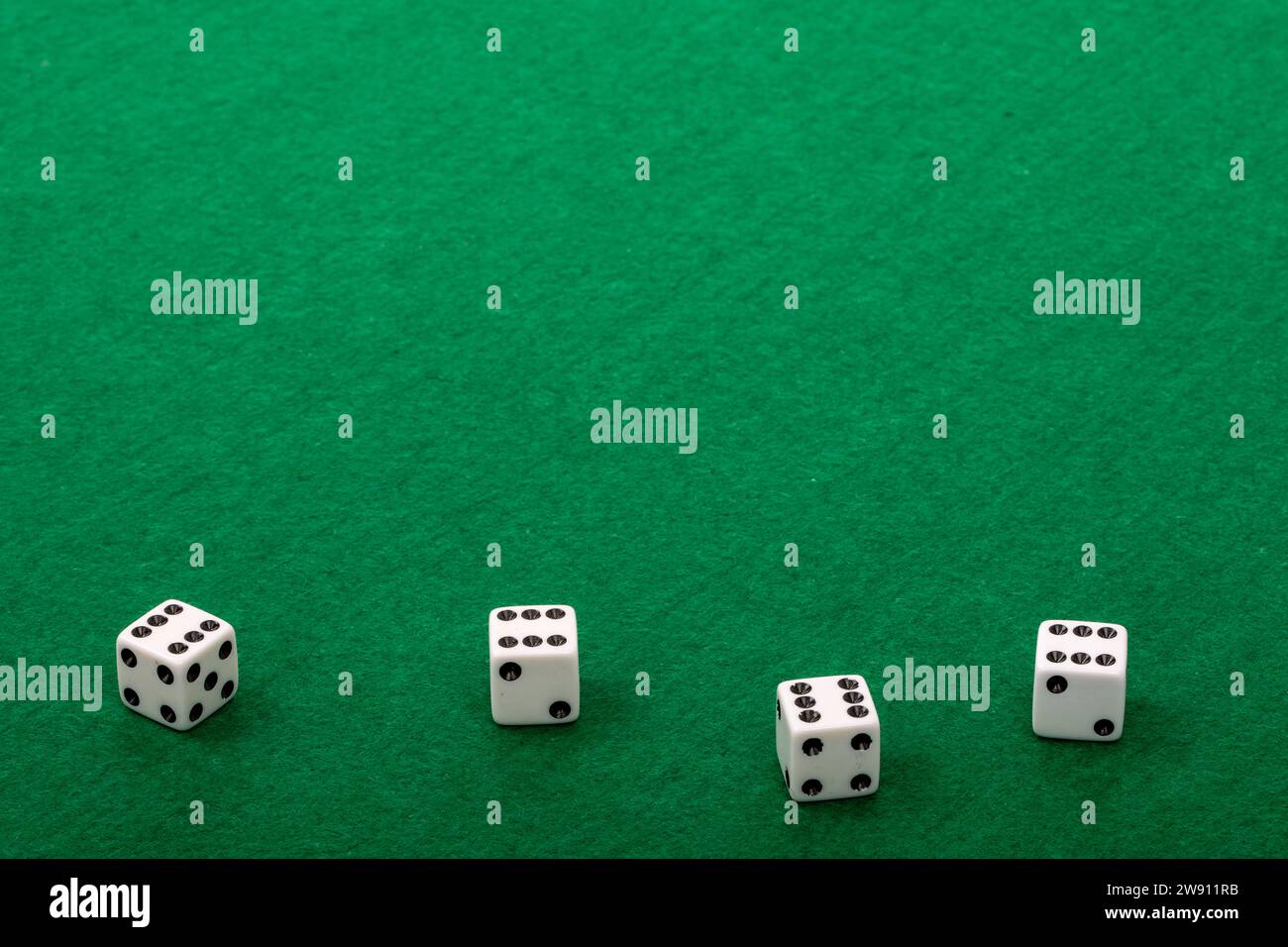 Four White Dice on Green Felt Background Stock Photo - Alamy