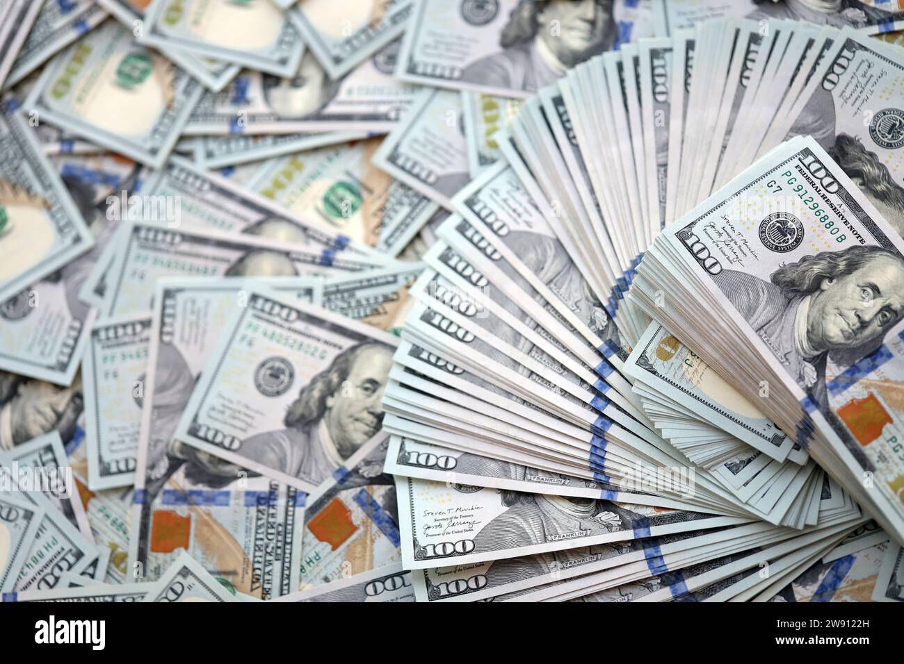 Very big amount of US hundred dollar bills close up. Huge quantity of ...