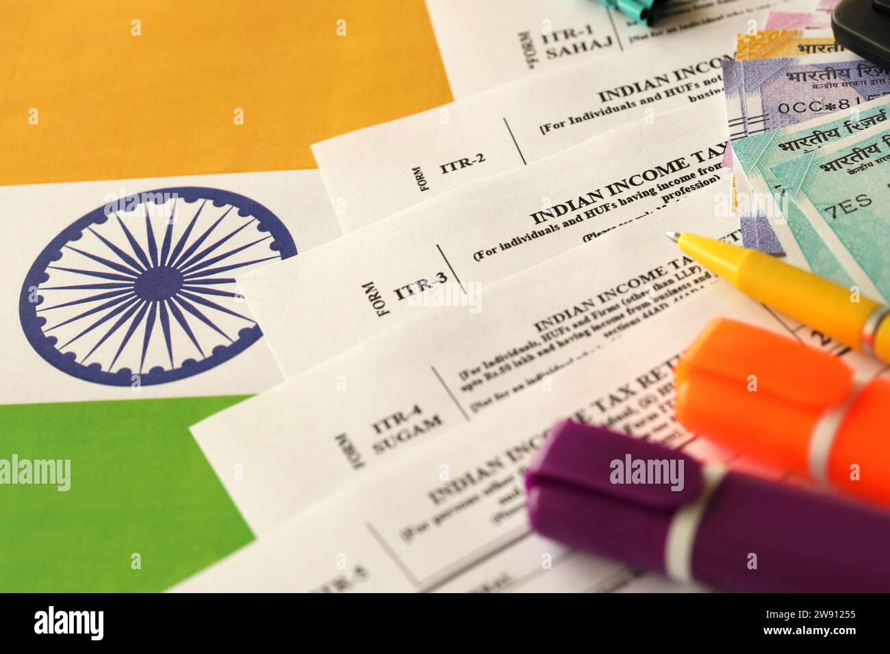 Indian income tax return blank form with pen and indian rupees bills on ...