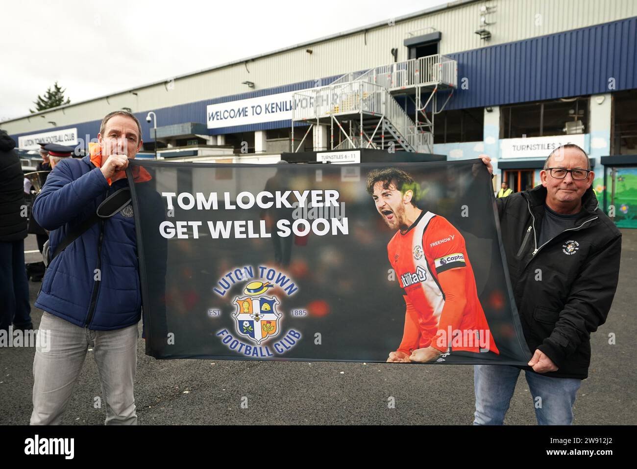 Luton Town fans hold up a banner of support for Tom Lockyer prior to ...