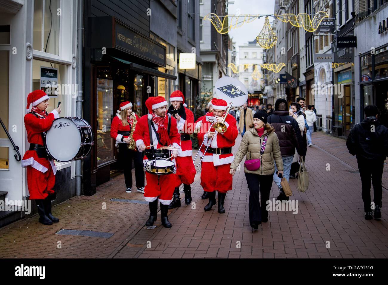 AMSTERDAM - A brass band dressed as Santa Clauses walk through the ...