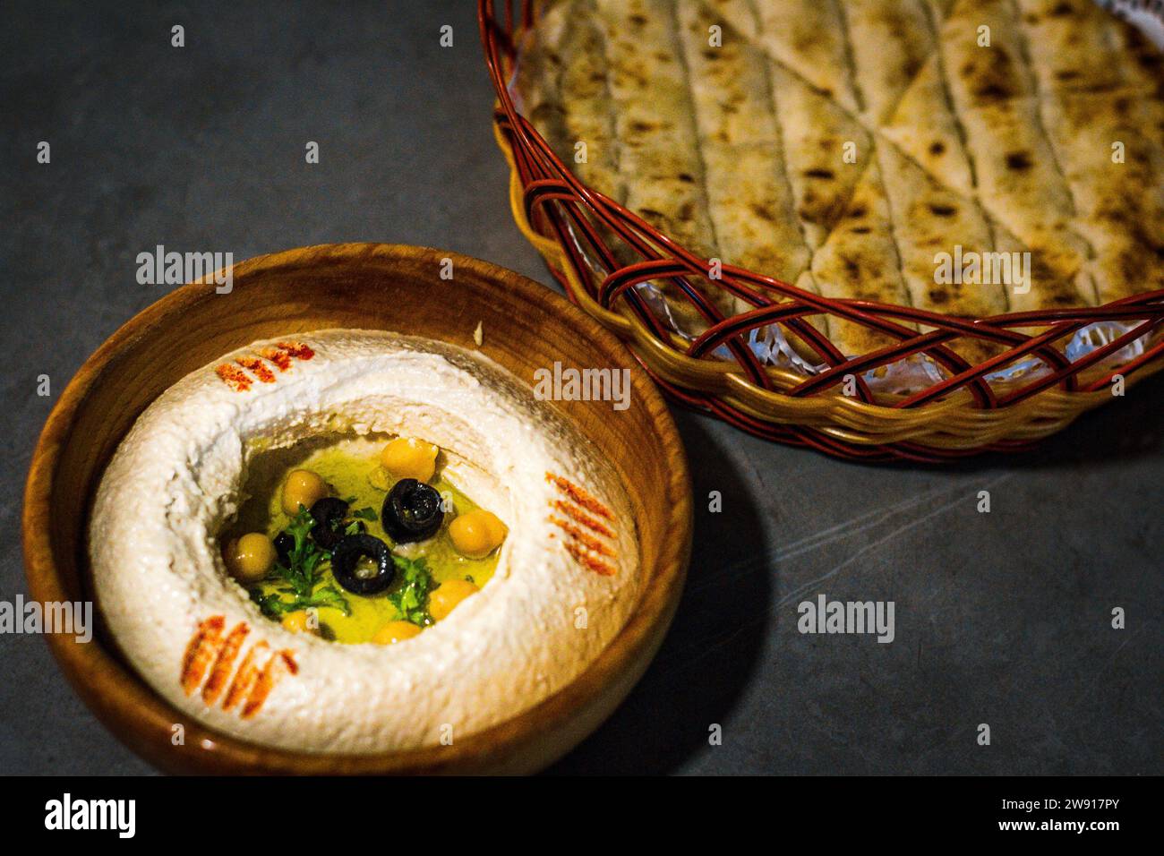 a serving of Cold Mezza - Hummus with olives, chick peas, olive oil ...
