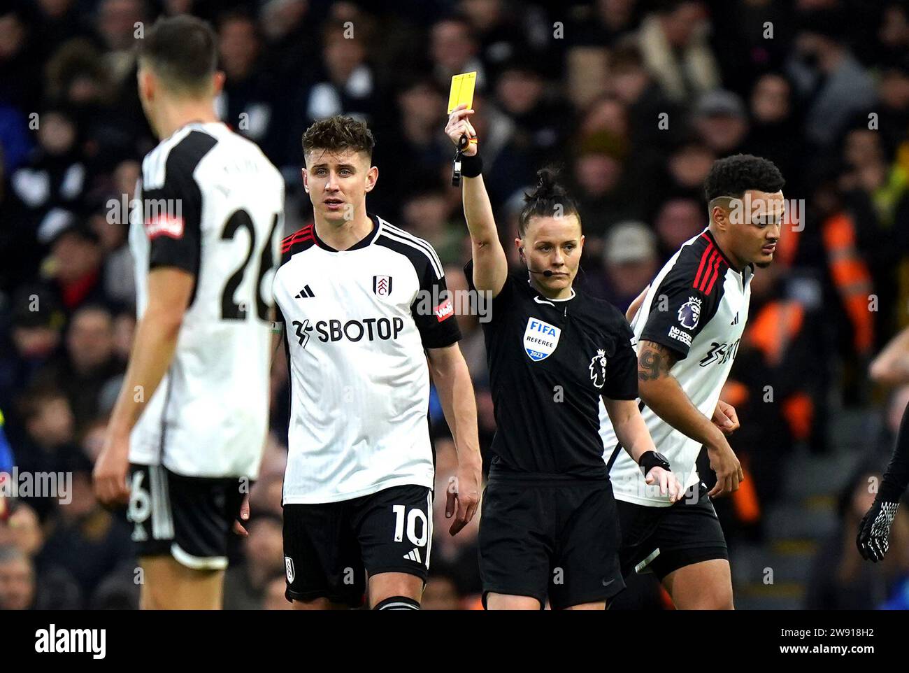 Referee Rebecca Welch (centre right) shows a yellow card to Fulham's ...