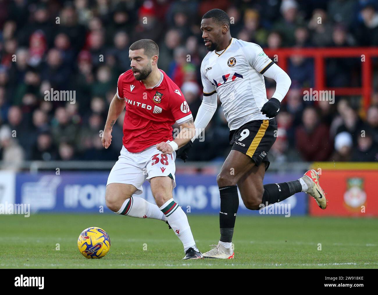 Wrexham’s Elliot Lee (left) is challenged by Newport County’s Omar ...