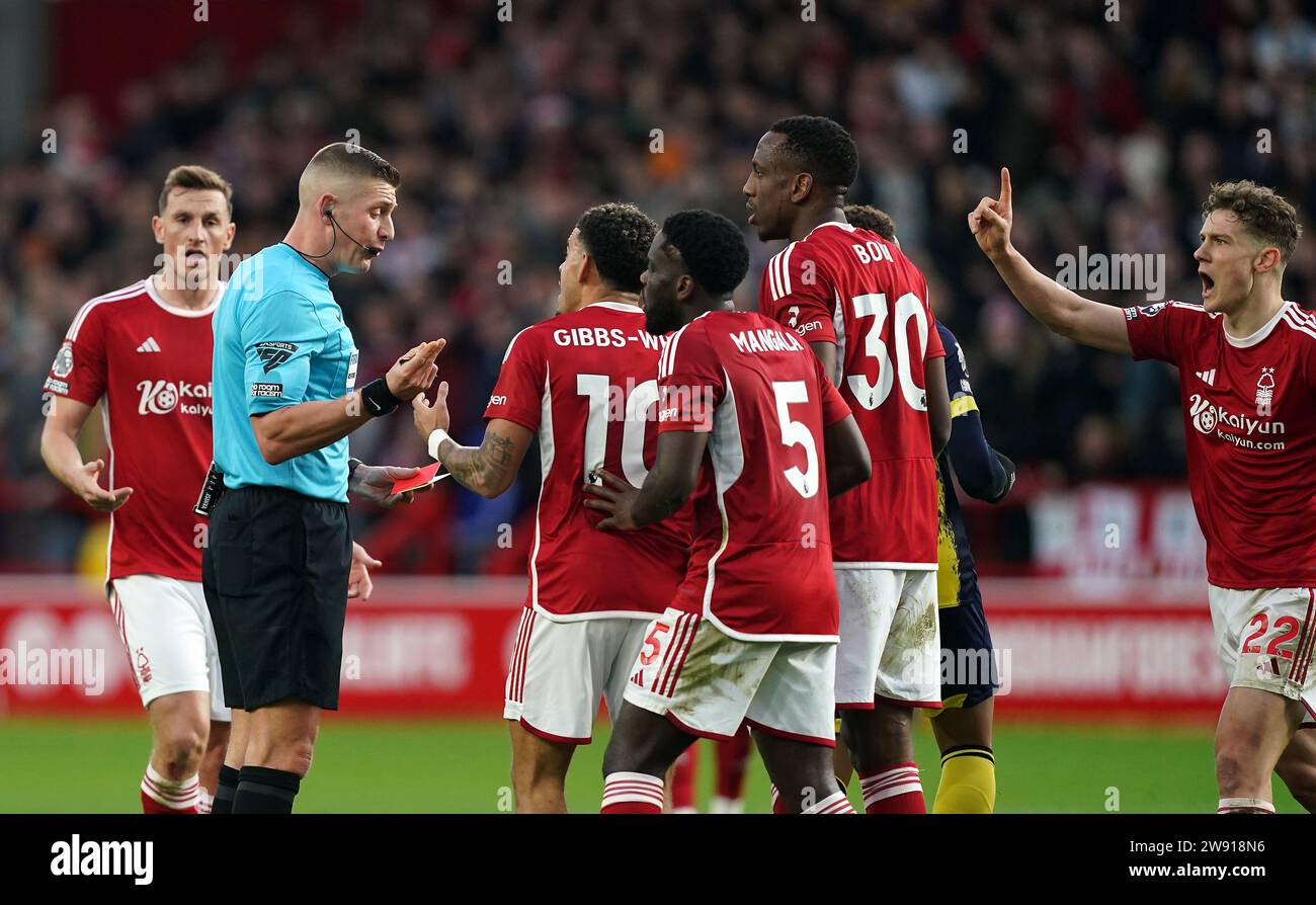 Referee Robert Jones shows a red card to Nottingham Forest's Willy Boly ...