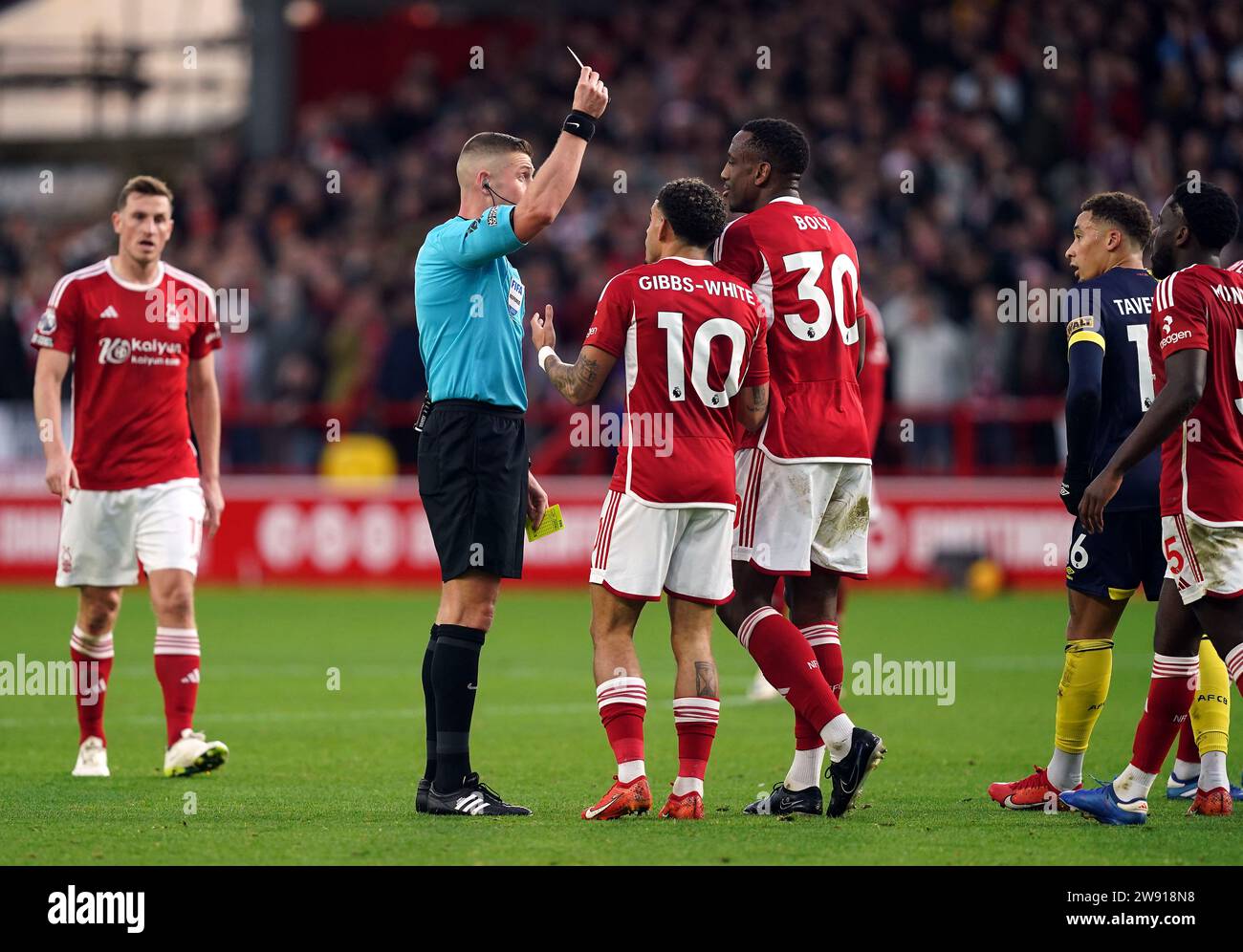 Referee Robert Jones shows a red card to Nottingham Forest's Willy Boly ...