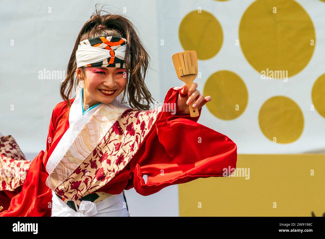 Young smiling happy Japanese woman yosakoi dancer dancing on stage in ...
