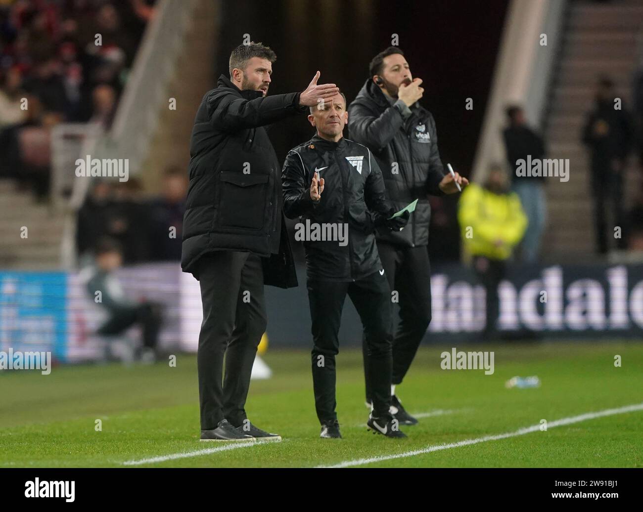Middlesbrough manager Michael Carrick (left) speaks with the fourth ...