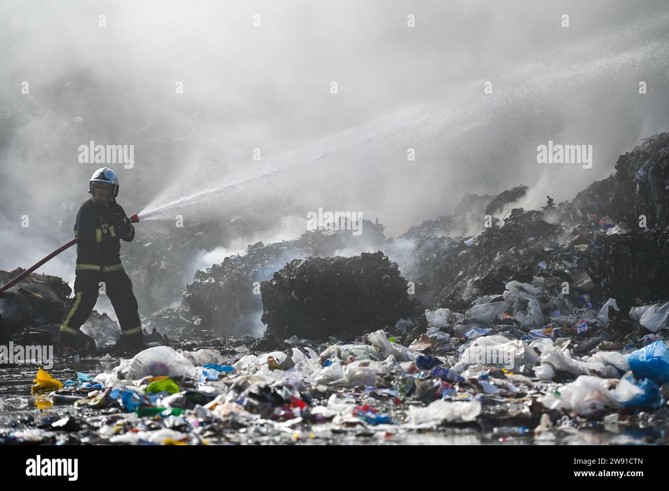 Naxxar, Malta. 23rd Dec, 2023. A firefighter works to extinguish a fire ...