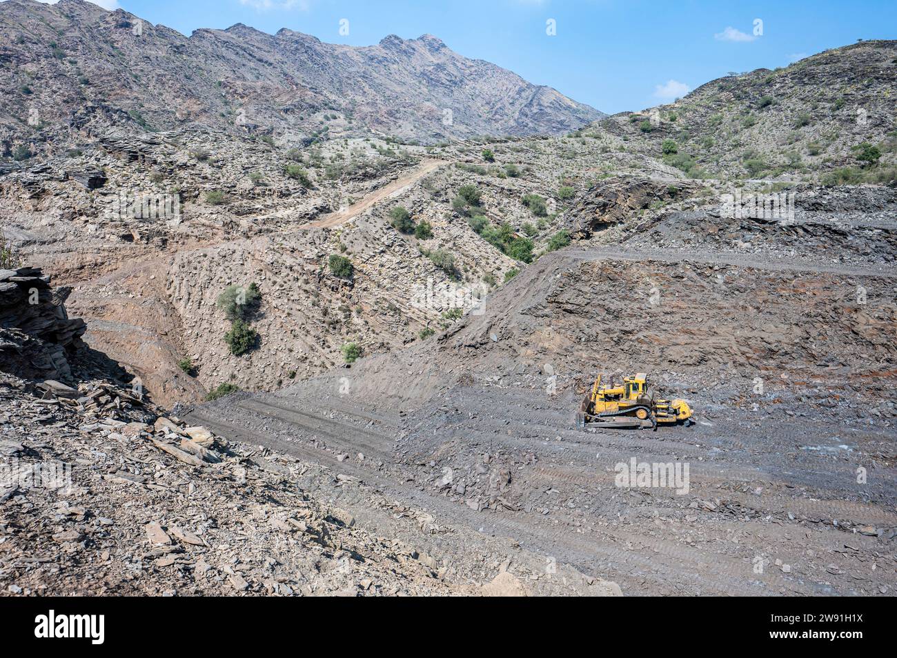 Heavy machinery in the process of mountain road construction works in ...