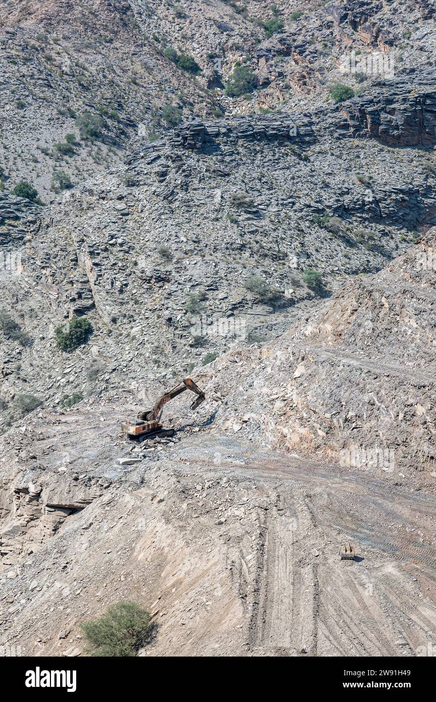 Heavy machinery in the process of mountain road construction works in ...