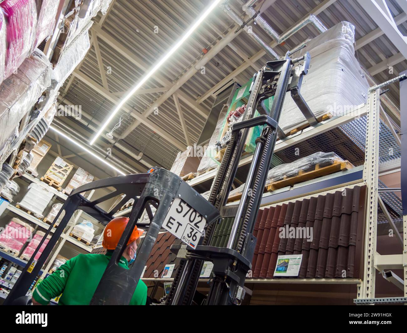 Voronezh, Russia - March 23, 2021: Stacking goods on a rack using a ...