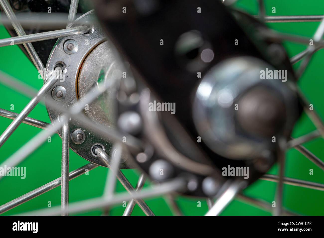 bicycle front wheel hub with spokes fitting detail on green background ...