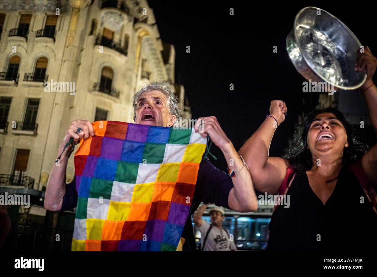 Buenos Aires, Buenos Aires, Argentina. 23rd Dec, 2023. Woman holds up high a wiphala, flag of ...