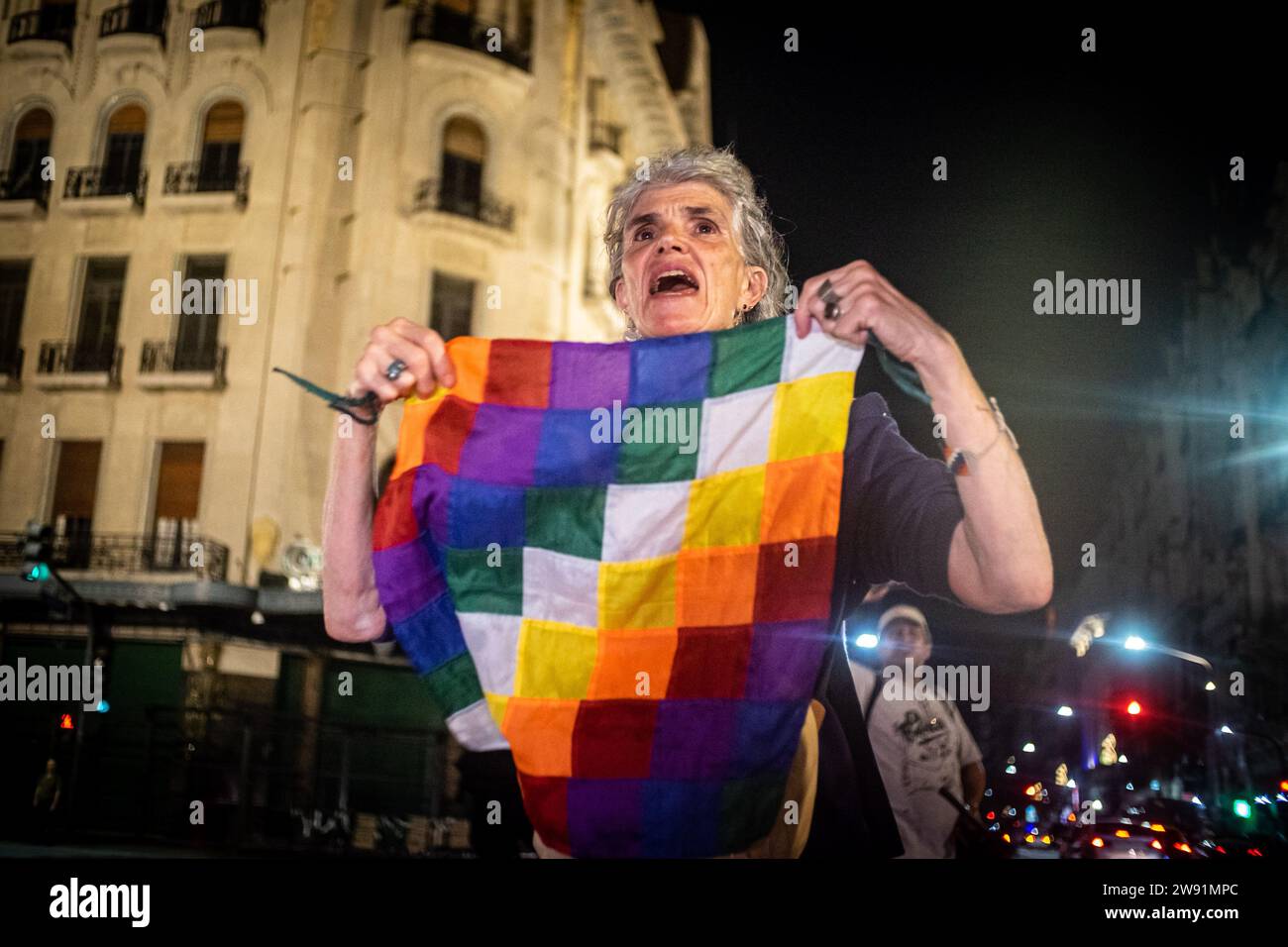 Buenos Aires, Buenos Aires, Argentina. 23rd Dec, 2023. Woman holds up high a wiphala, flag of ...