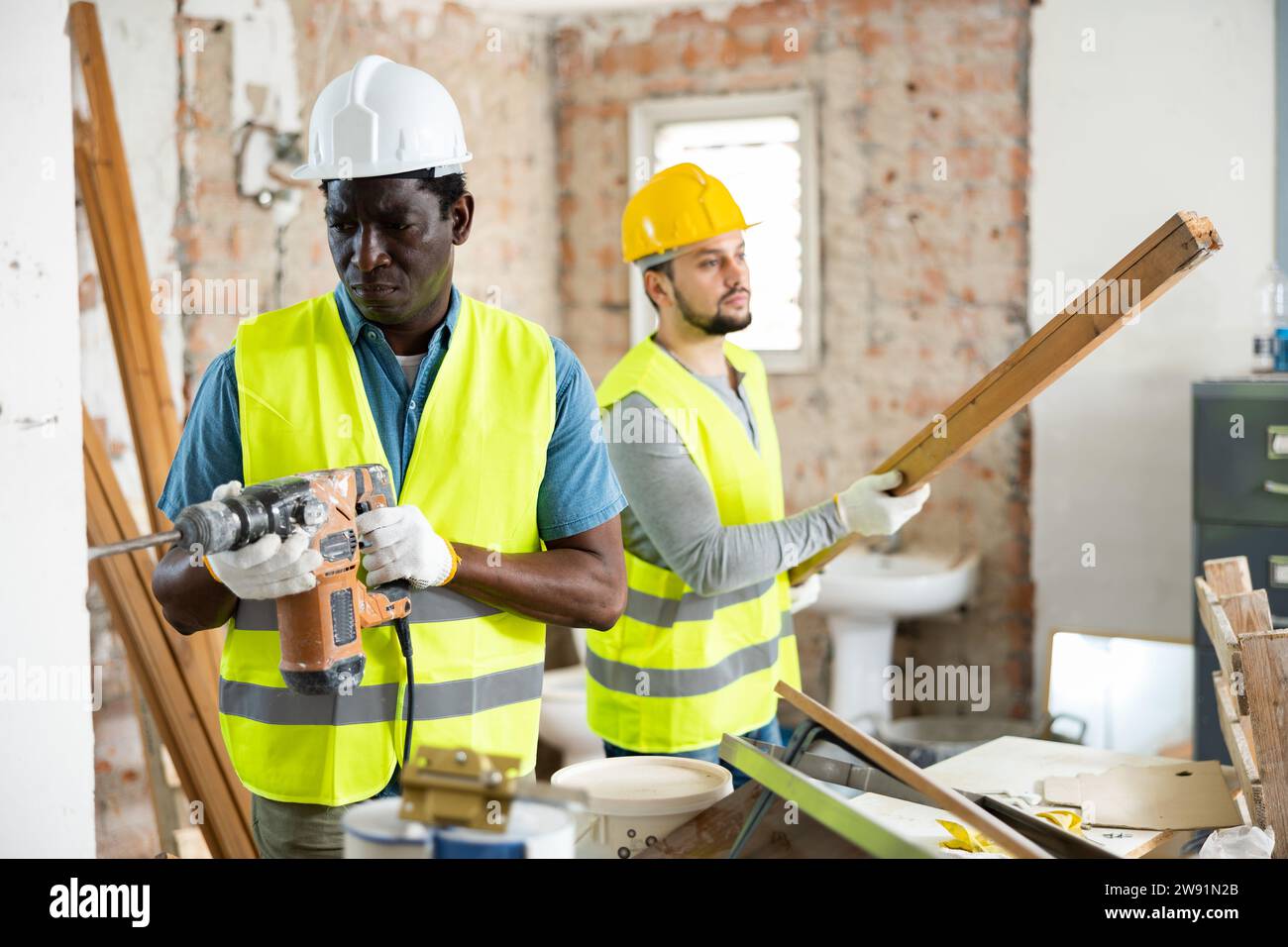 Team of workers is renovating a room in cottage Stock Photo - Alamy