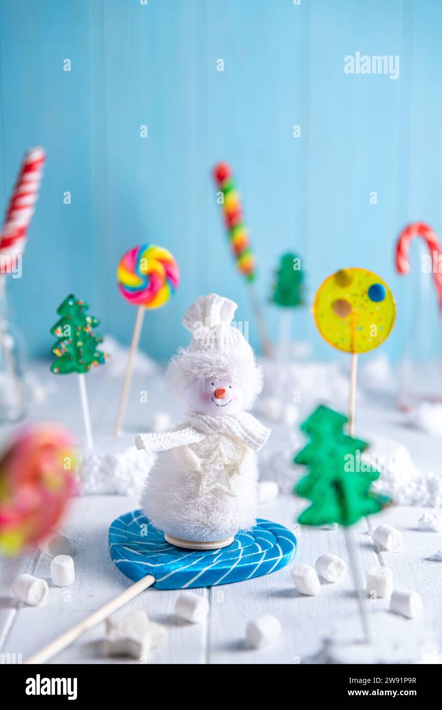 A bright light composition of multi-colored lollipops. Snowman, New ...