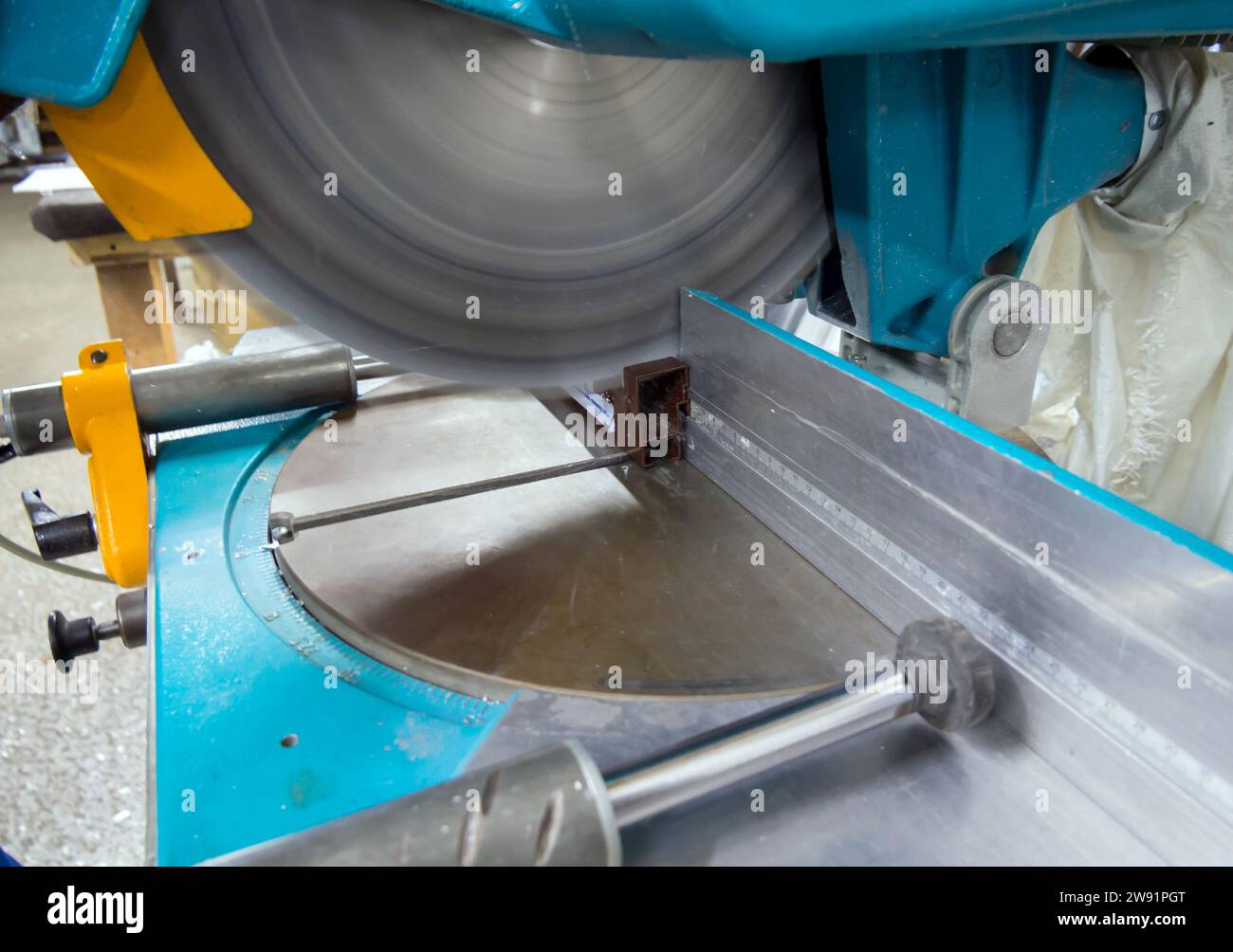 Cutting an aluminum profile on a stationary circular saw Stock Photo ...