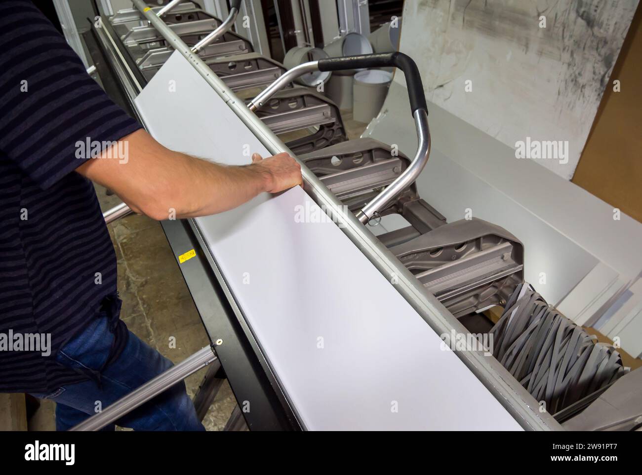 Making a mold from sheet metal on a manual bending machine Stock Photo ...