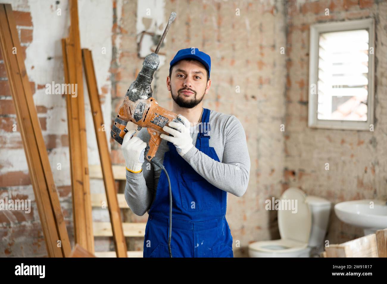 Puncher in hands builder man hi-res stock photography and images - Alamy