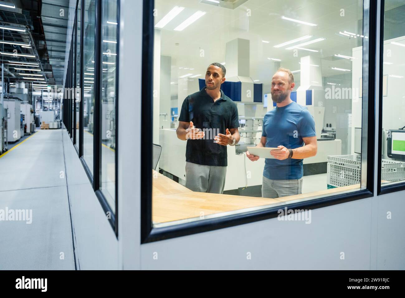 Two colleagues with digital tablet having a meeting in a factory Stock ...