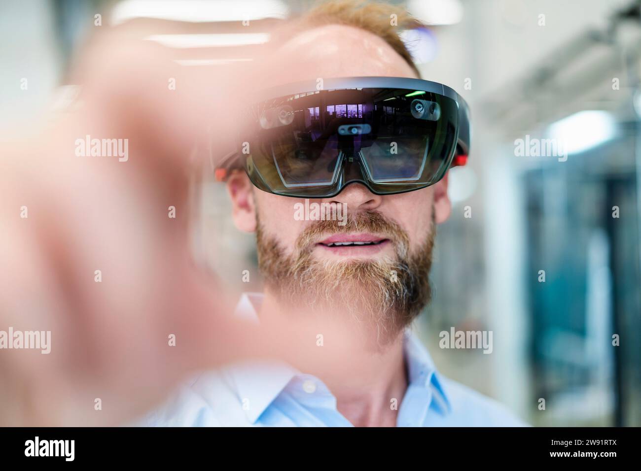Technician wearing augmented reality glasses and gesturing Stock Photo ...