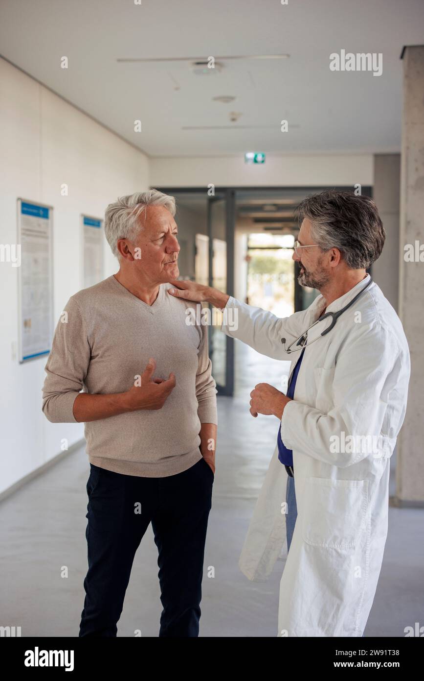 Male senior doctor standing in hospital corridor hi-res stock ...