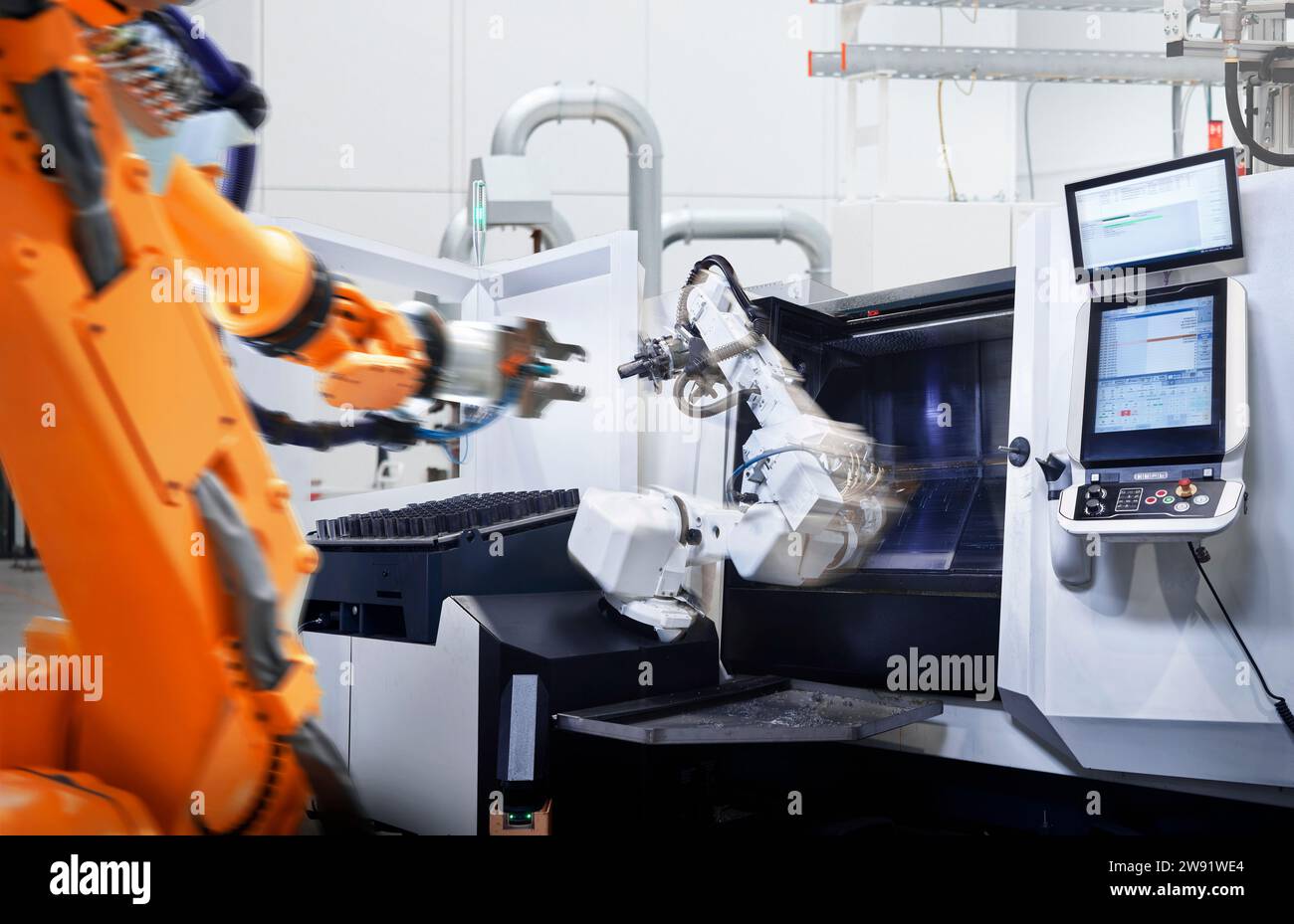 Automated orange robotic arms hi-res stock photography and images - Alamy