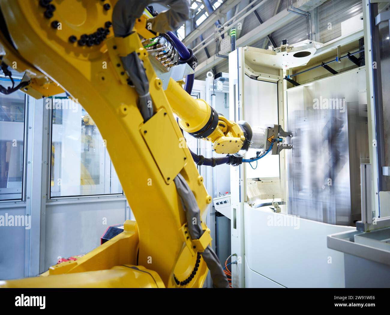 Yellow robotic arm in factory Stock Photo - Alamy