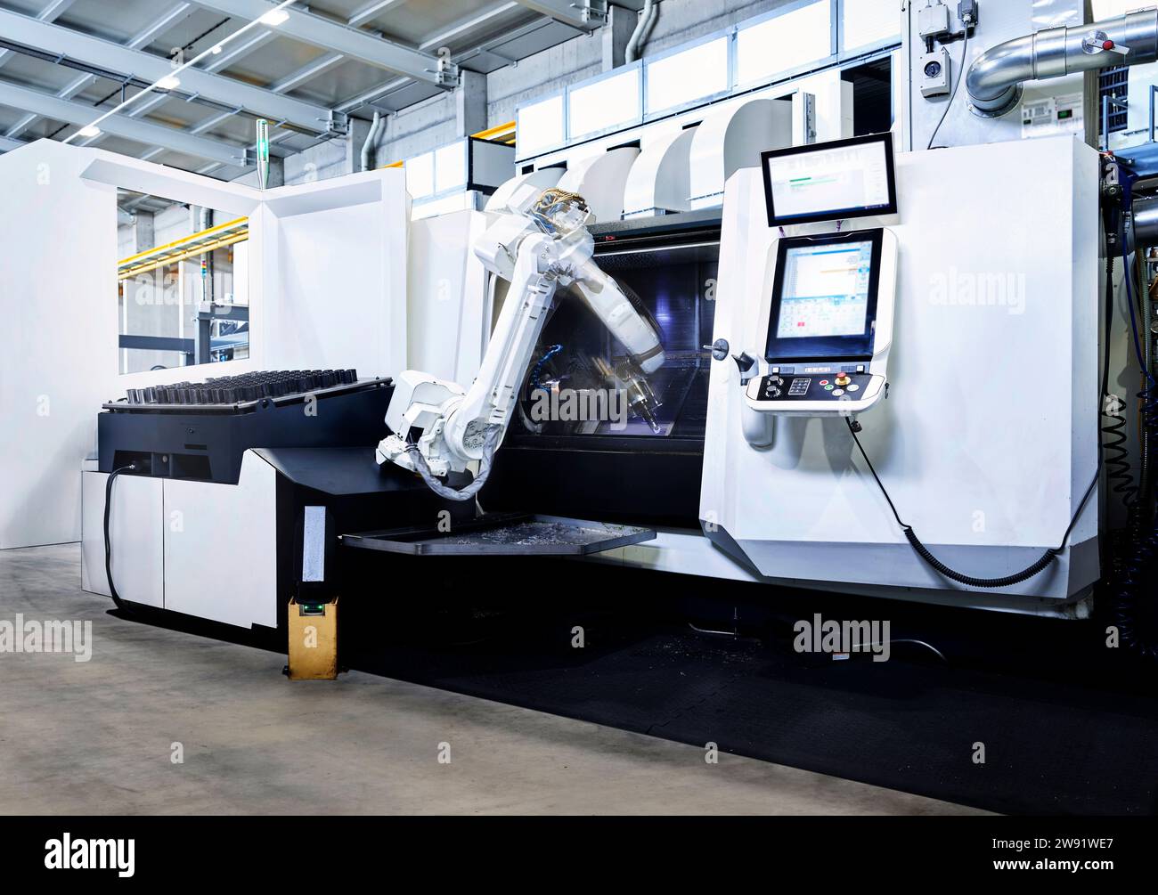 Robotic arm with machine in factory Stock Photo - Alamy