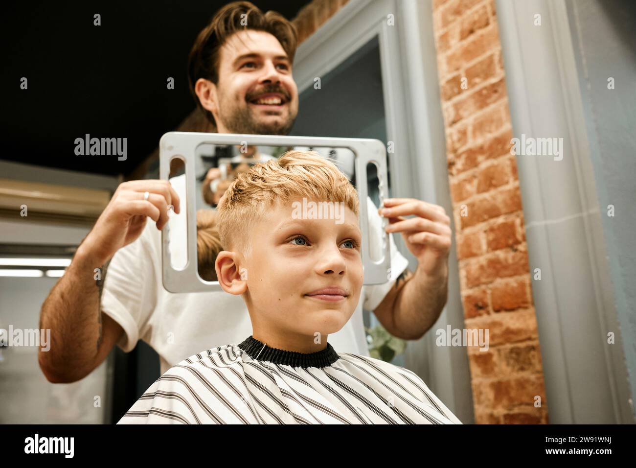 Happy hairdresser showing haircut to customer in mirror at salon Stock ... Happy hairdresser showing haircut to customer in mirror at salon Stock ...