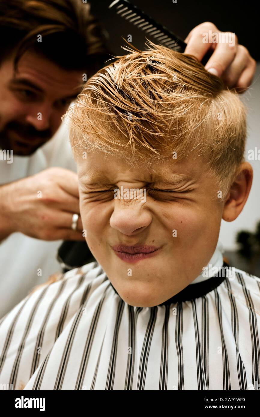 Customer getting haircut by barber Stock Photo - Alamy