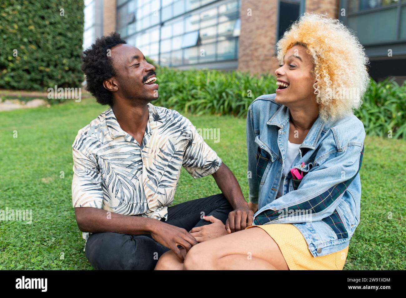 Happy transgender woman enjoying with boyfriend sitting at park Stock ...