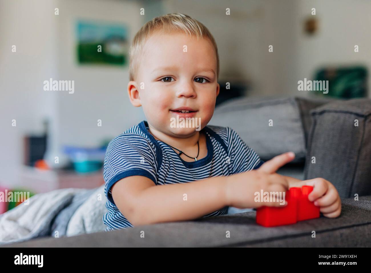 Cute boy playing with toy blocks at home Stock Photo - Alamy