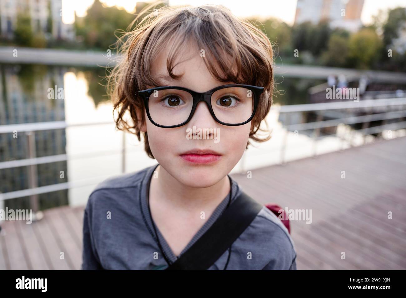 Cute boy wearing eyeglasses on bridge Stock Photo - Alamy