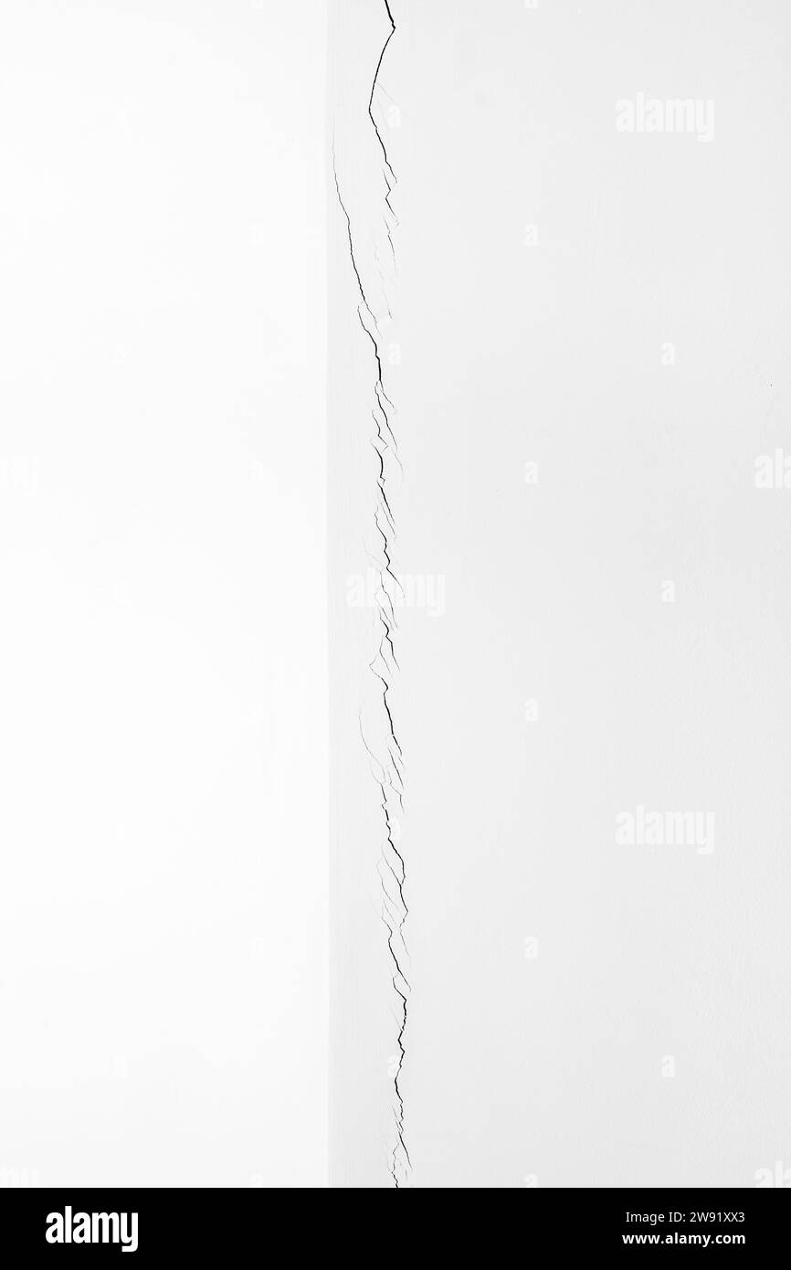 Long, deep crack in the white wall. Construction problems. Shrinkage of ...