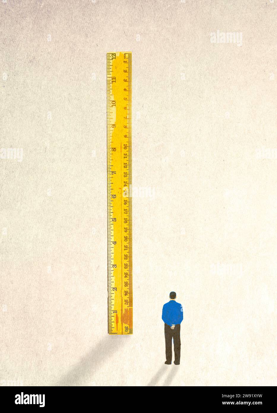 Man looking at oversized ruler Stock Photo - Alamy