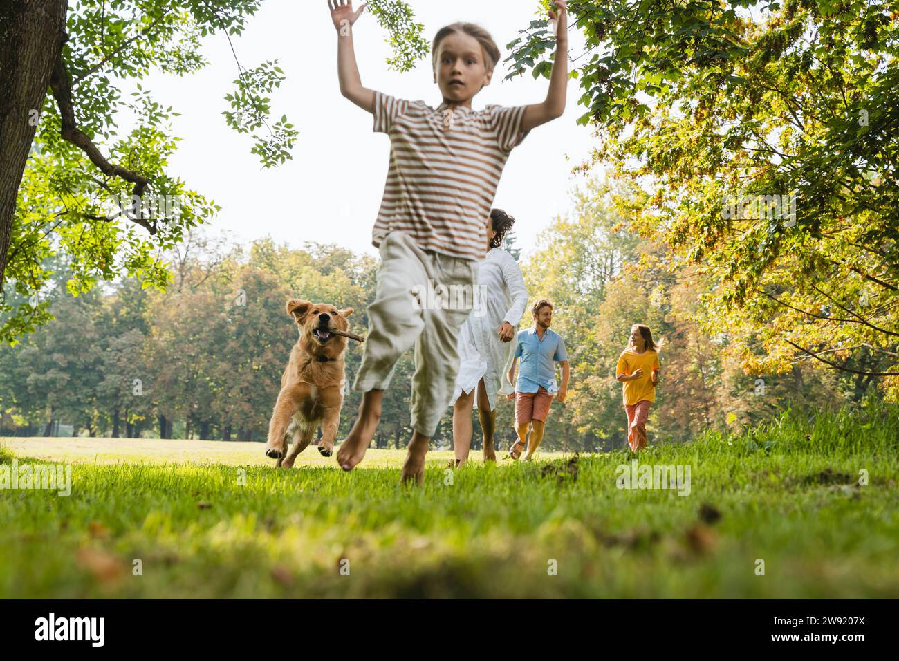 Family running with dog hi-res stock photography and images - Alamy