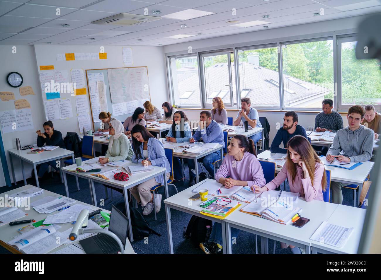 Multi-ethnic students at desk learning in educational training class ...