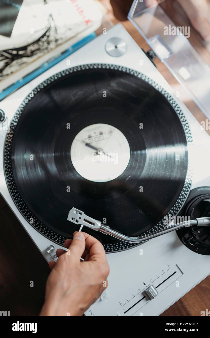 Hand of man adjusting tonearm of turntable at home Stock Photo - Alamy