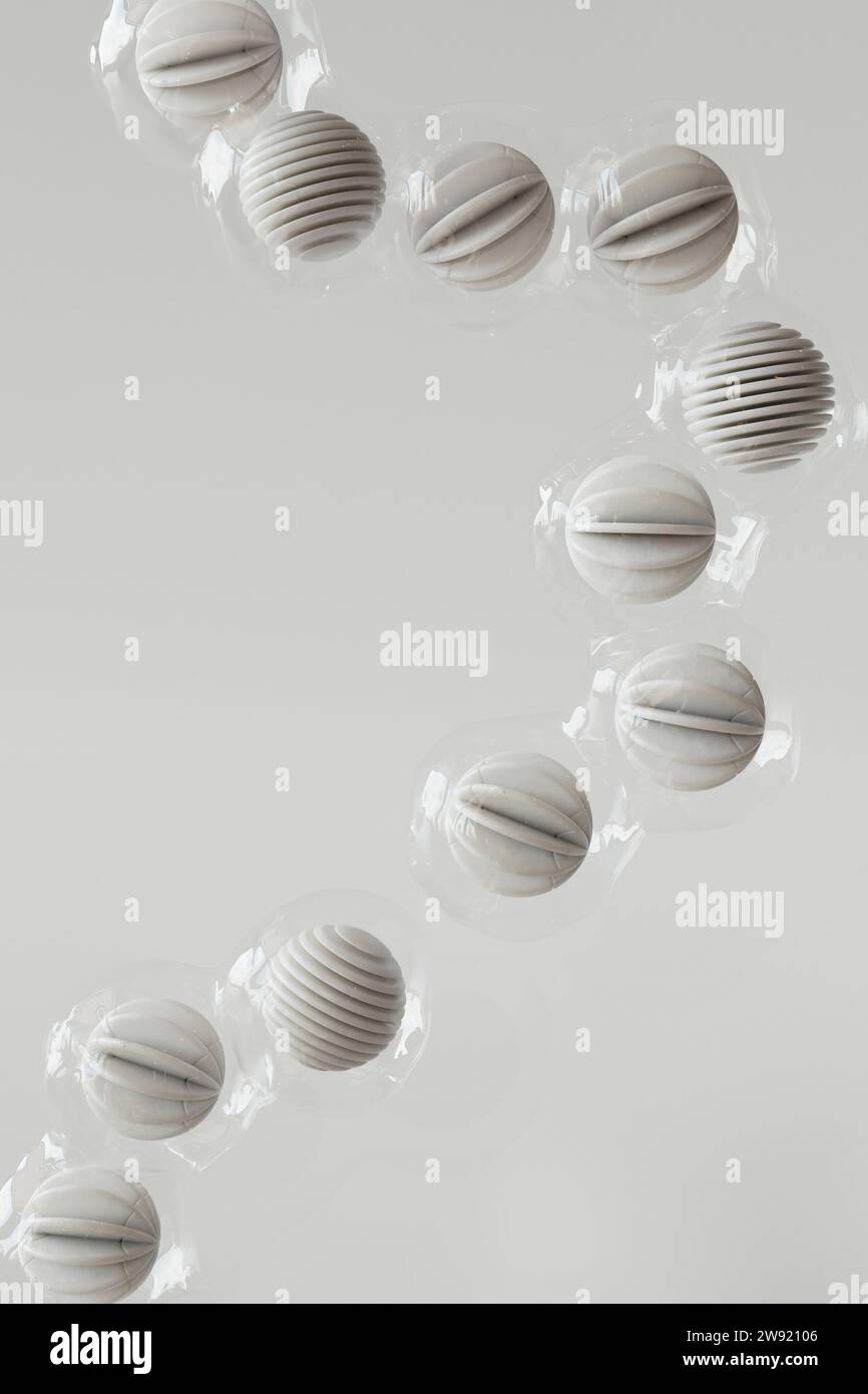 3D render of row of plastic wrapped spheres floating against white ...