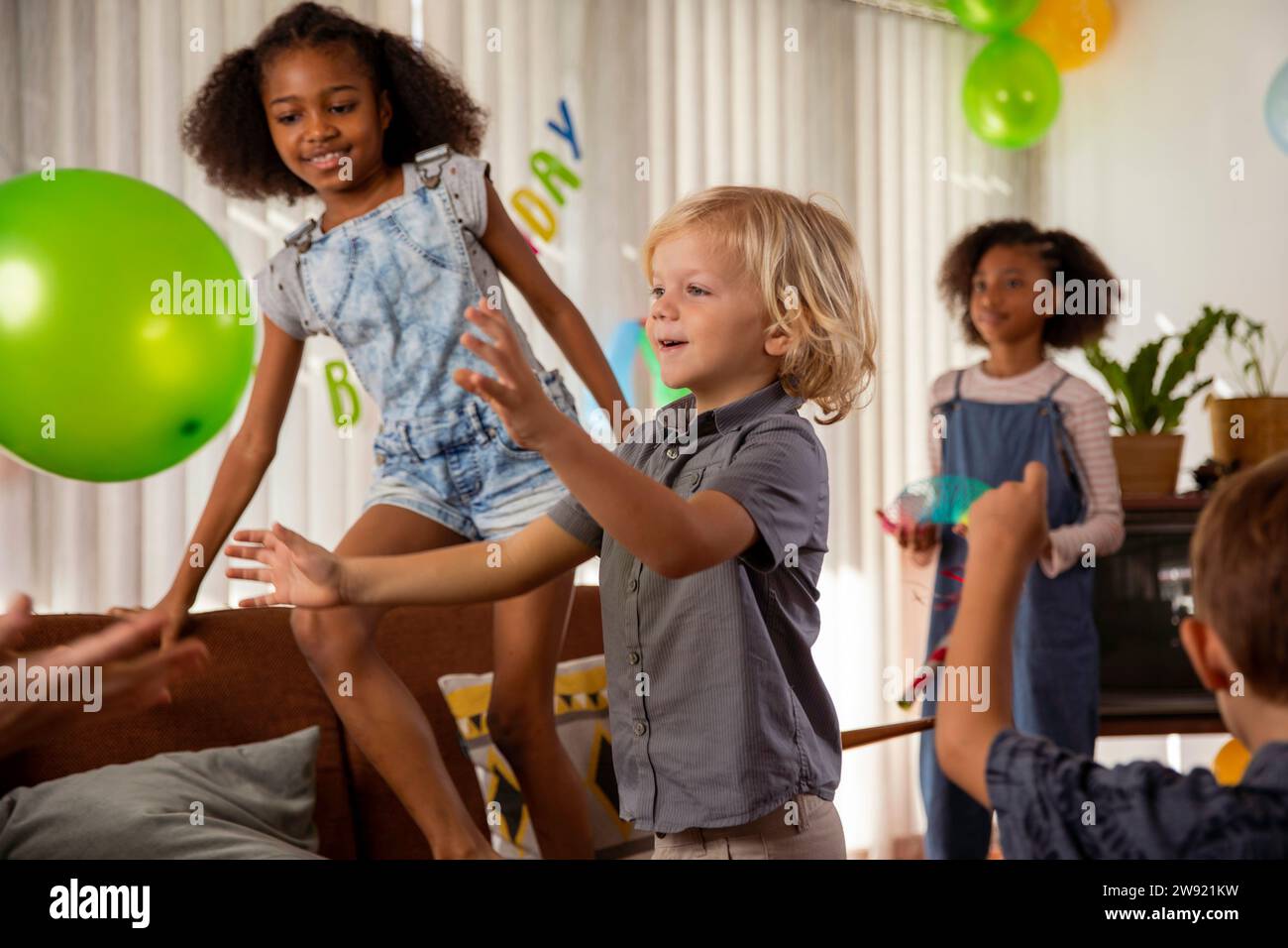 Happy children playing with balloons at home Stock Photo - Alamy