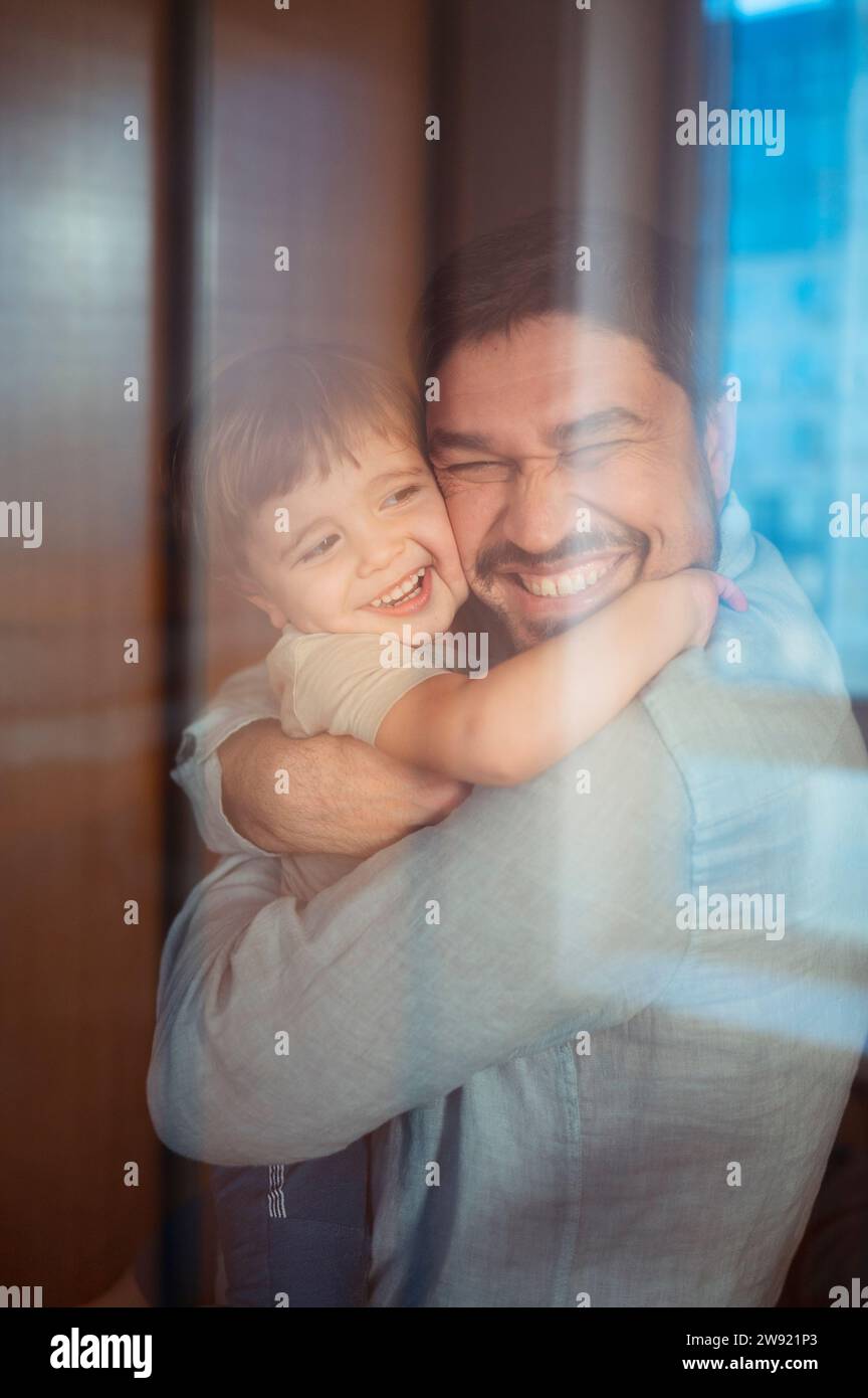 Happy father hugging son at home Stock Photo - Alamy