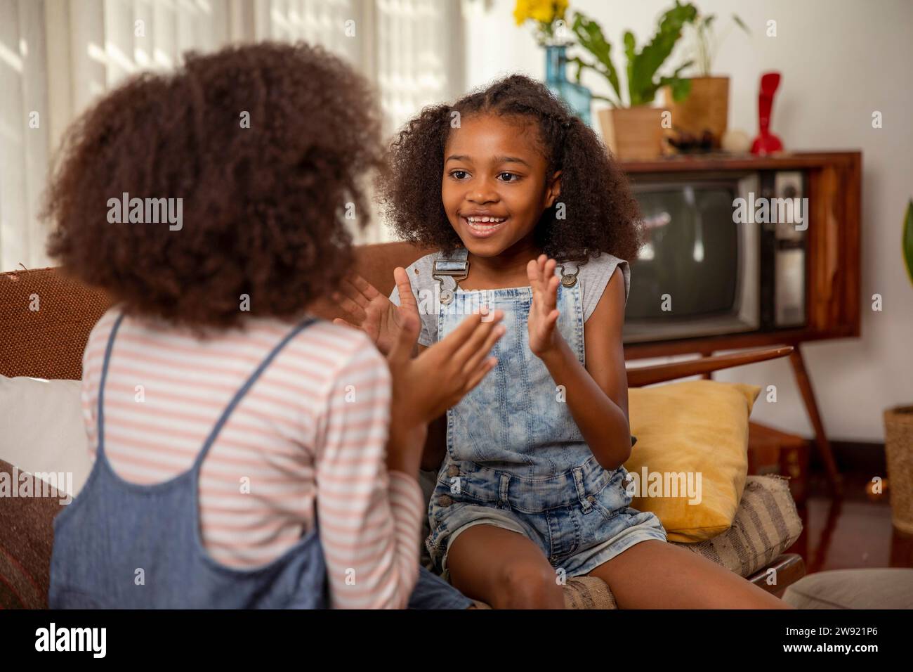 Girls playing clapping game at home Stock Photo - Alamy