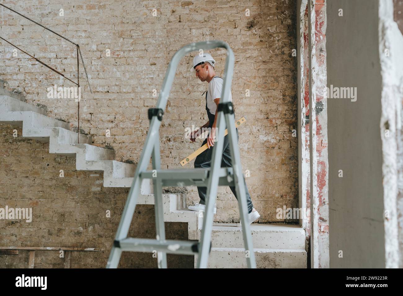 Civil engineer moving up on staircase at site Stock Photo - Alamy