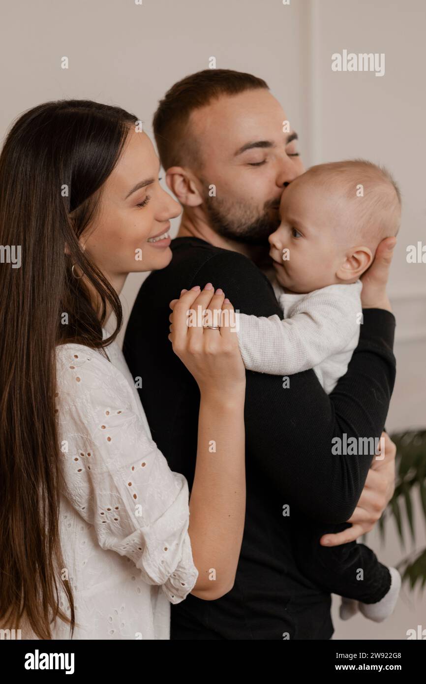 Loving parents embracing son at home Stock Photo - Alamy