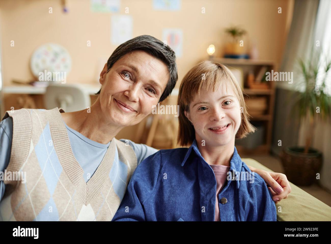 Smiling mother and her daughter with Down syndrome at home Stock Photo ...