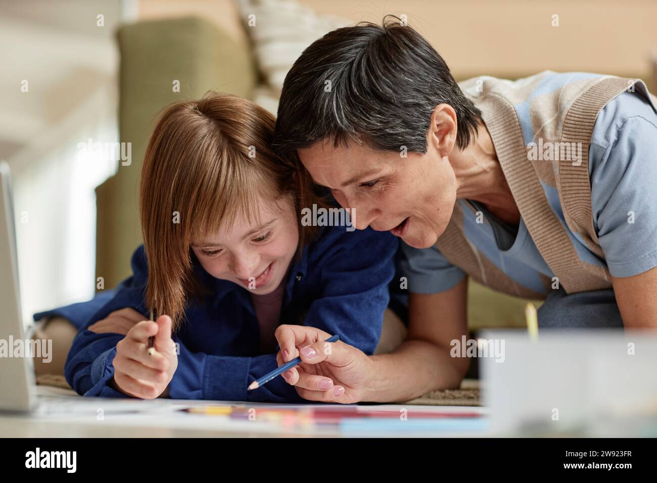 Mother and her daughter with disability drawing at home Stock Photo - Alamy